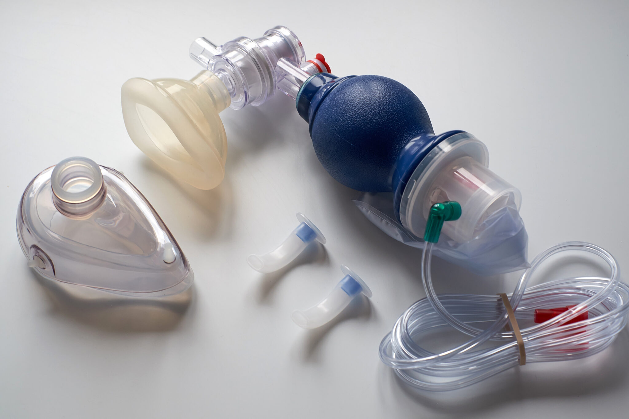 On the table are an Ambu bag with an oxygen mask and medical airways ...